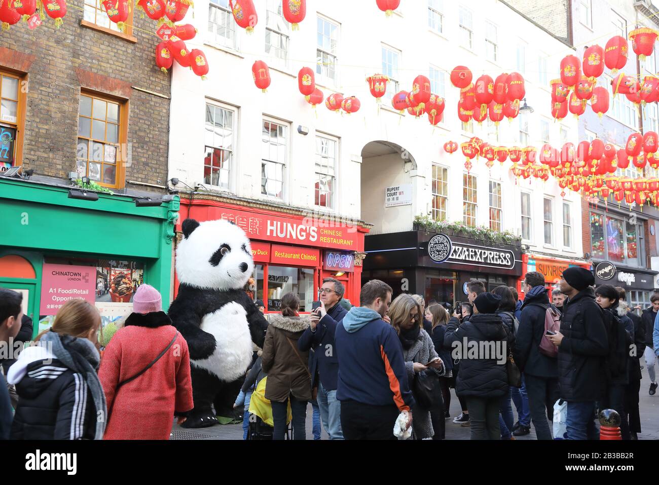 Costumed giant panda entertaining the tourists on Wardour Street, in ...