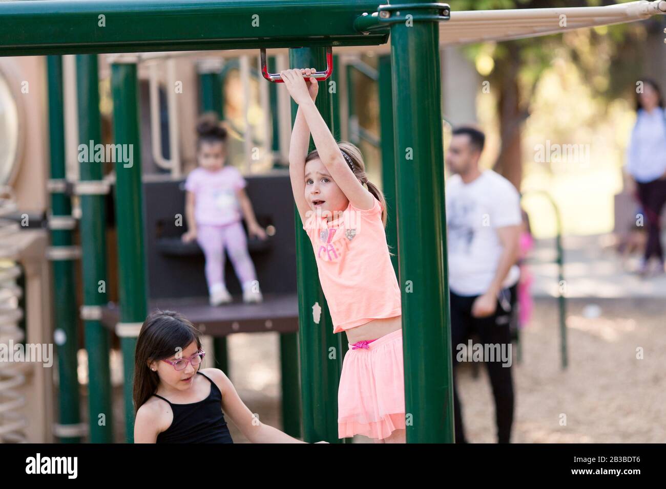 Sisters are playing and using teamwork on the playground Stock Photo ...