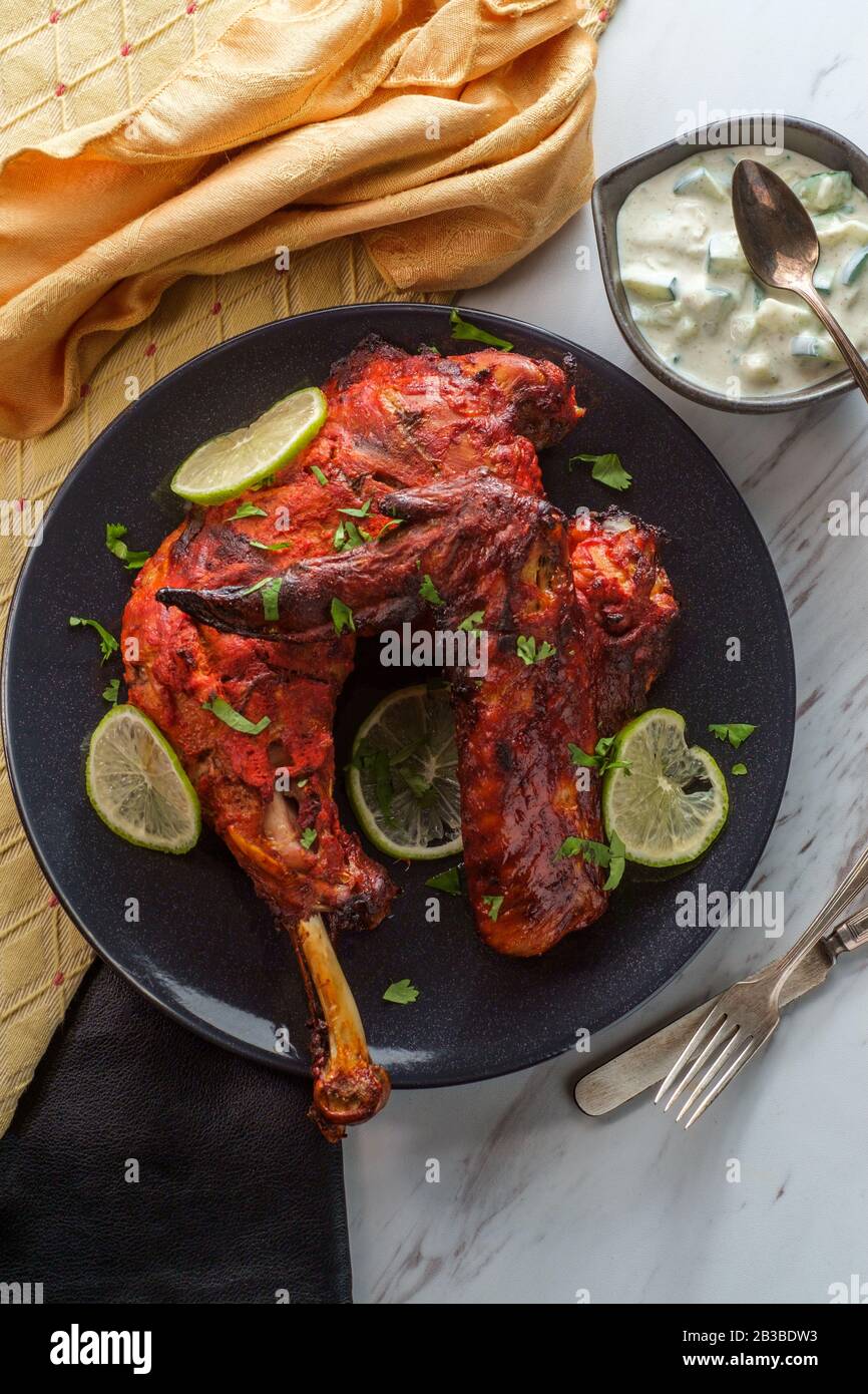 Indian cuisine spicy red Tandoori chicken with cucumber raita Stock ...