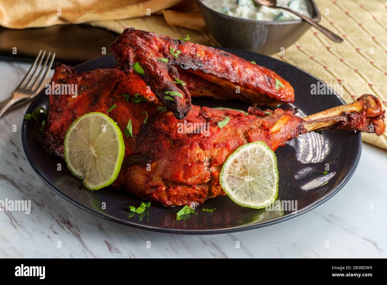 Indian cuisine spicy red Tandoori chicken with cucumber raita Stock ...