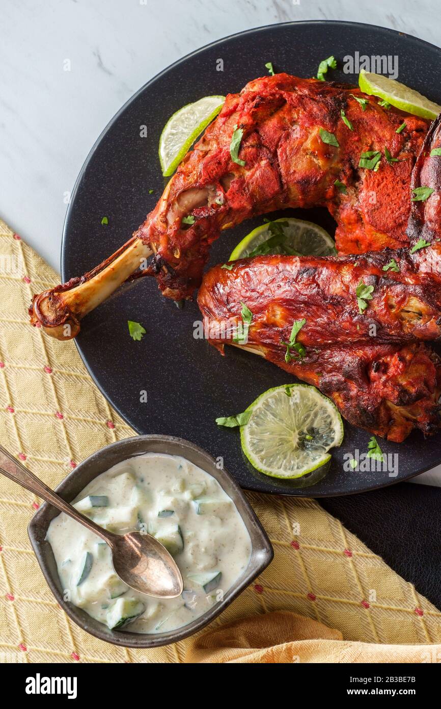 Indian cuisine spicy red Tandoori chicken with cucumber raita Stock ...