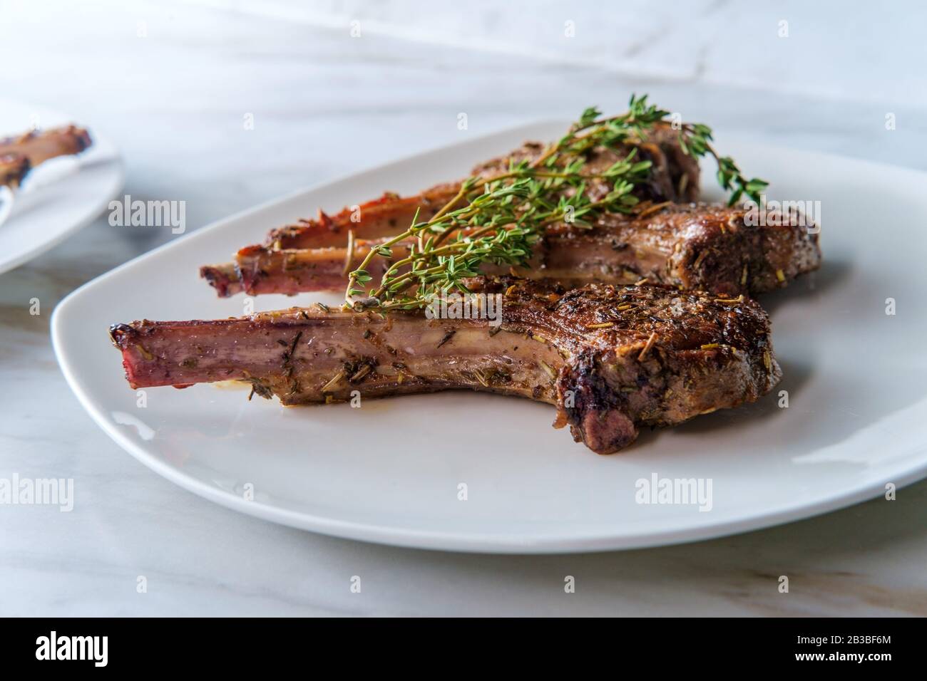 Fancy and simple marinated French lamb rib with thyme garnish Stock ...