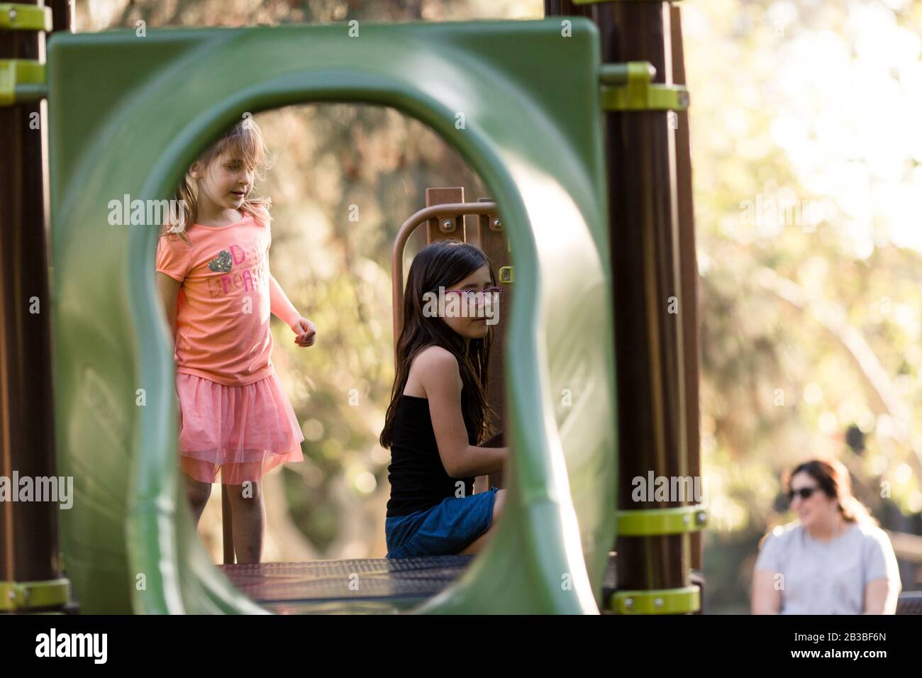 Sisters are playing and using teamwork on the playground Stock Photo ...