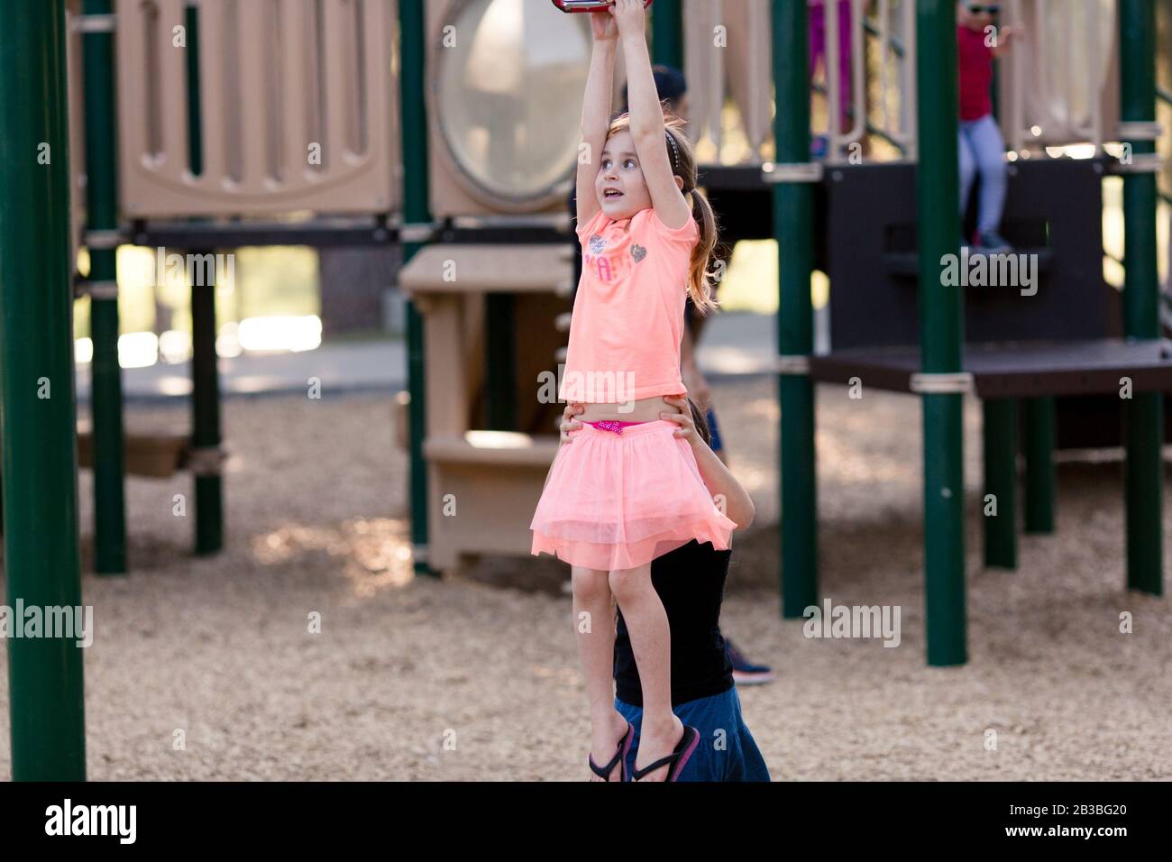 Sisters are playing and using teamwork on the playground Stock Photo ...