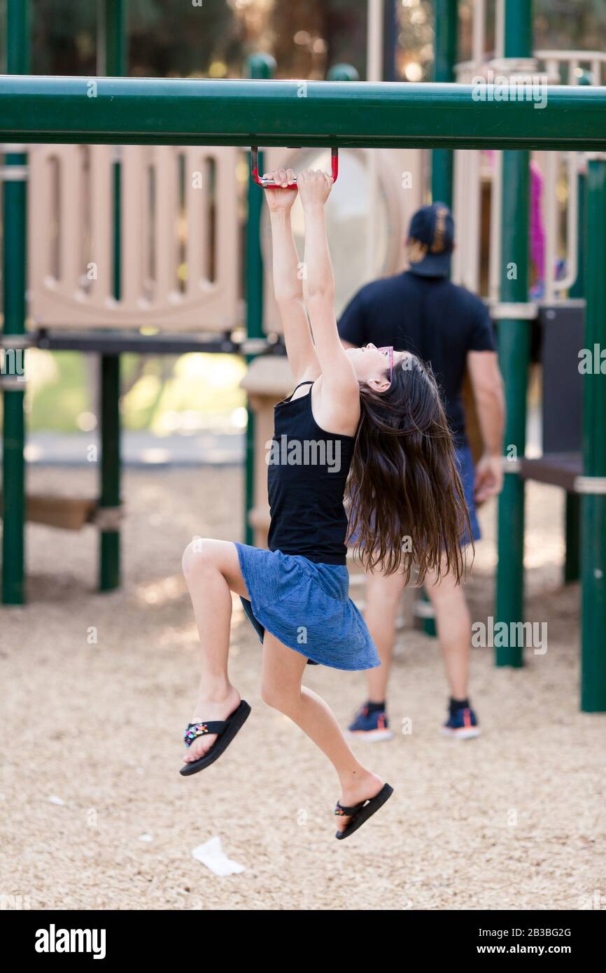 Sisters are playing and using teamwork on the playground Stock Photo ...