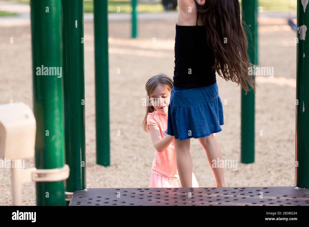 Sisters are playing and using teamwork on the playground Stock Photo ...