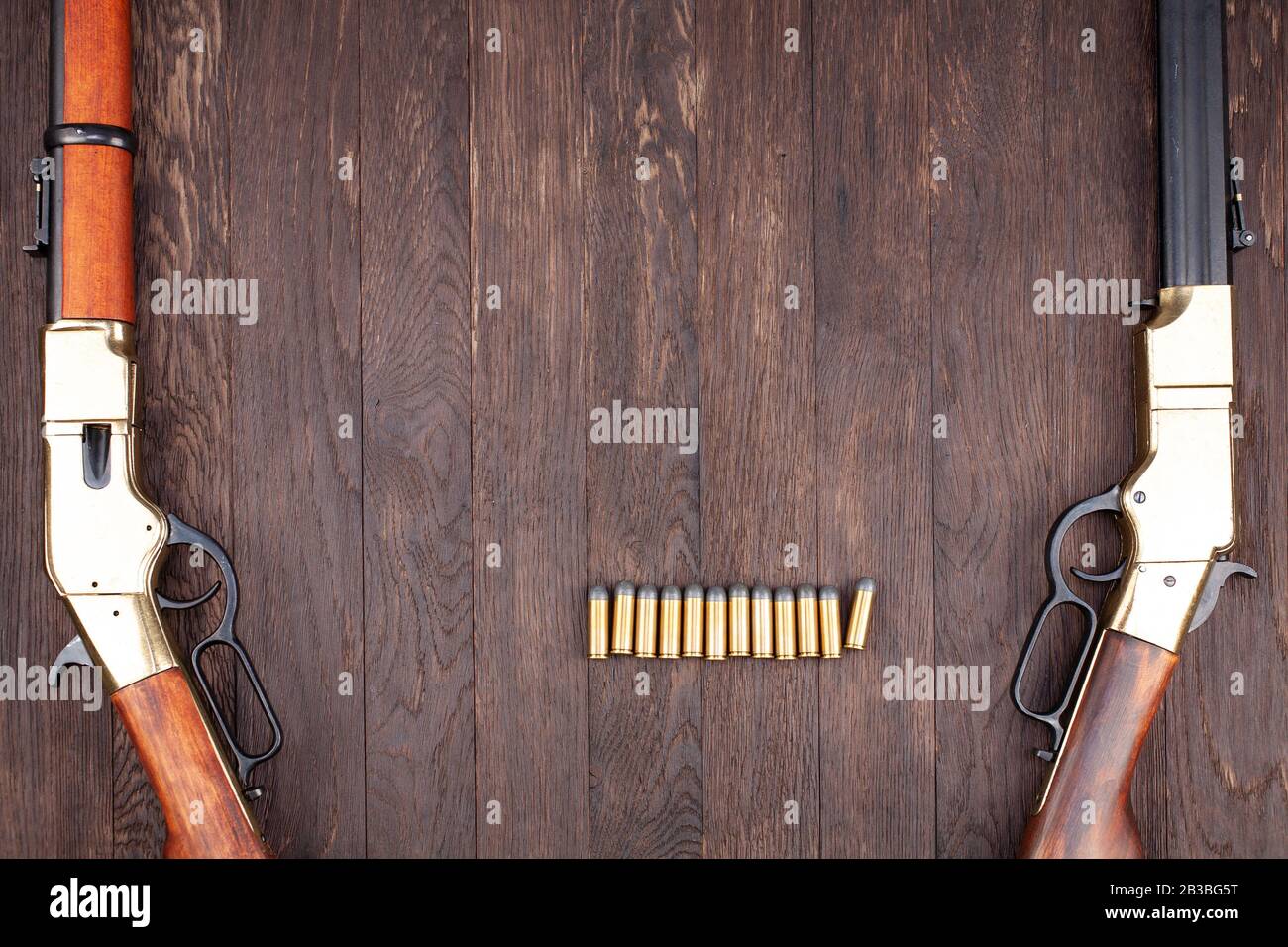 Wild west guns - lever-action repeating rifles with ammunition on ...