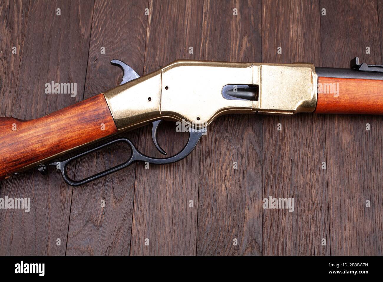 Wild west gun - lever-action repeating rifle on wooden table Stock ...