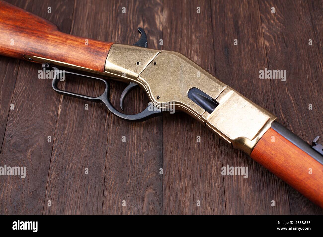 Wild west gun - lever-action repeating rifle on wooden table Stock ...