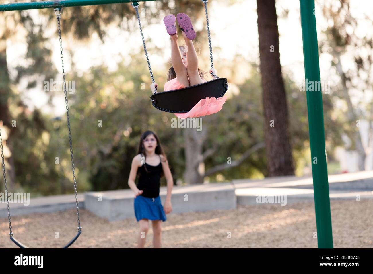 Sisters are playing and using teamwork on the playground Stock Photo ...