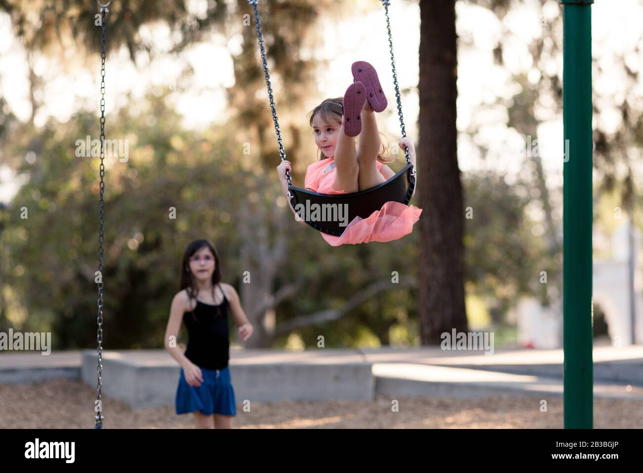 Sisters are playing and using teamwork on the playground Stock Photo ...