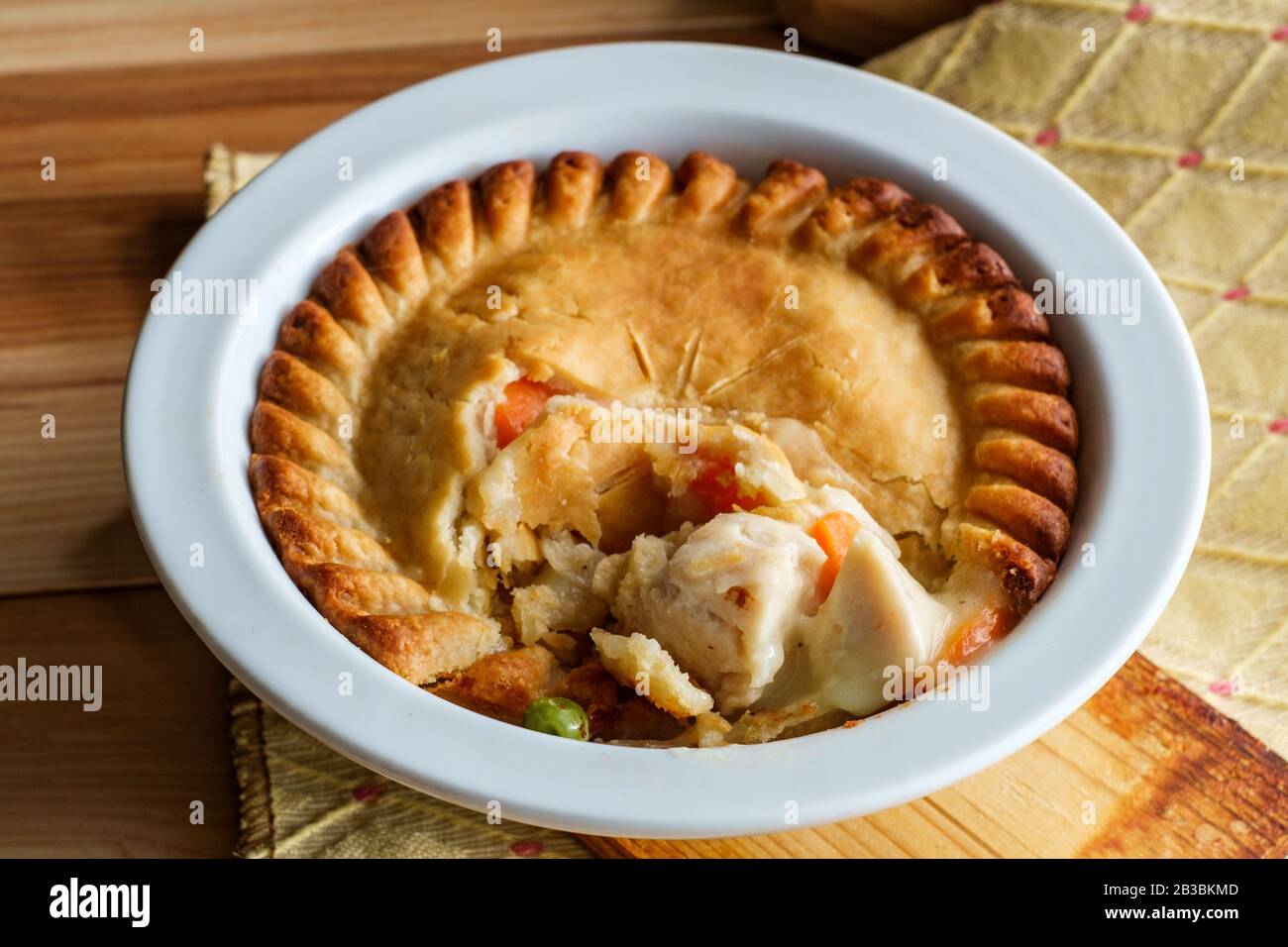 Crispy flaky baked chicken pot pie in white bowl Stock Photo - Alamy