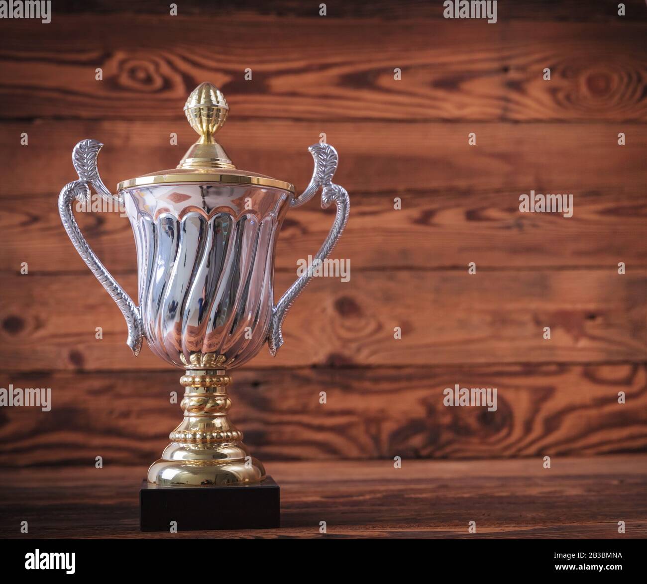 first place trophy award on old wood background Stock Photo - Alamy