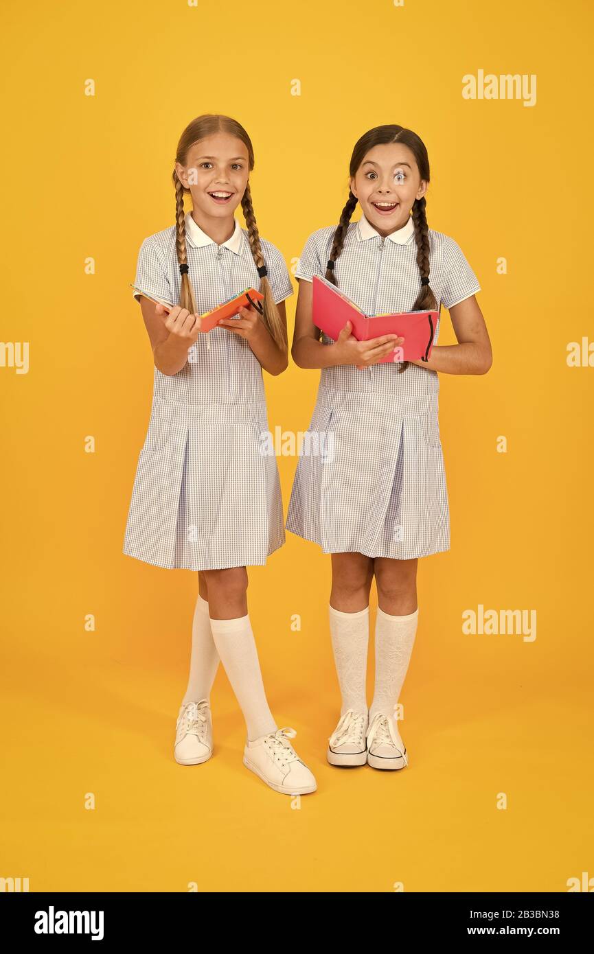 Sincere interest. Little girls with encyclopedia or childrens books ...