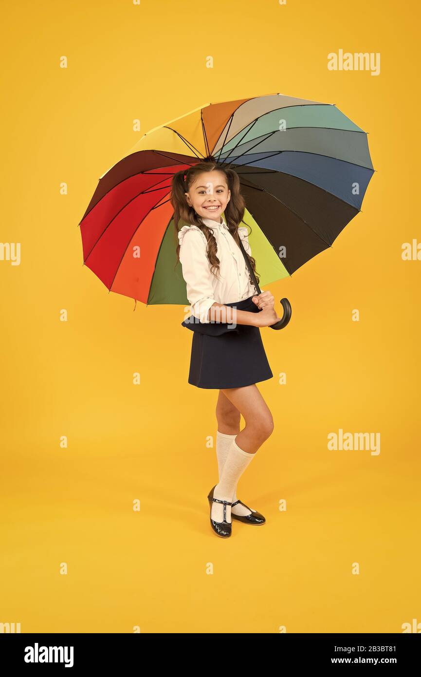 Fancy schoolgirl. Girl with umbrella. Rainy day. Happy childhood. Kid happy with umbrella. Fall ...