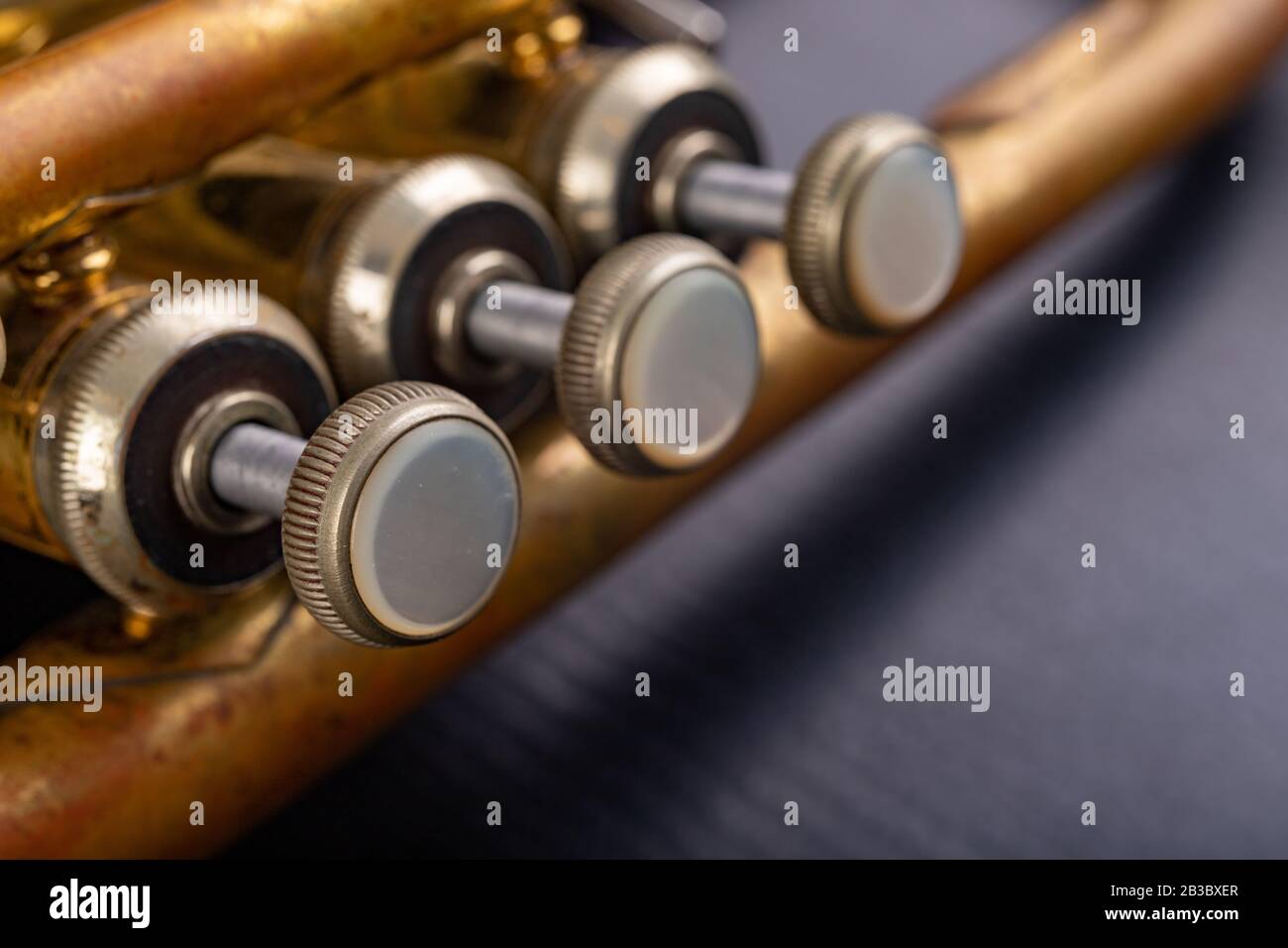 Details of an old patina covered trumpet. Musical instrument shown in ...