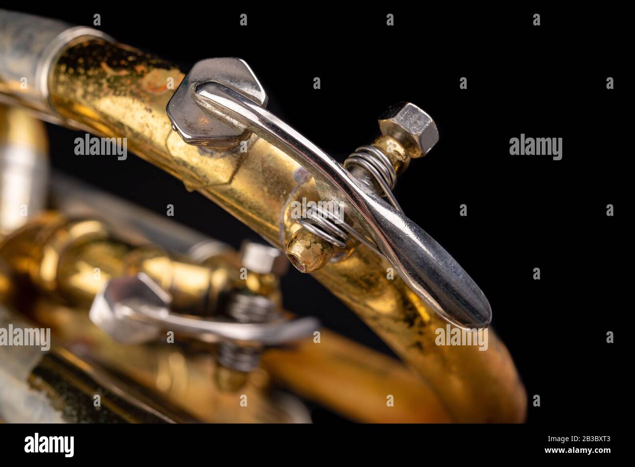 Details of an old patina covered trumpet. Musical instrument shown in ...