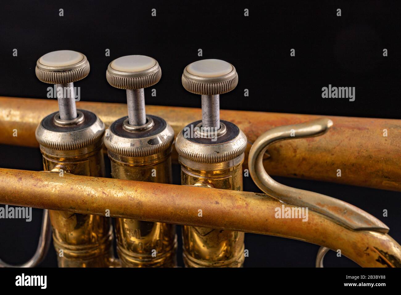 Details of an old patina covered trumpet. Musical instrument shown in ...