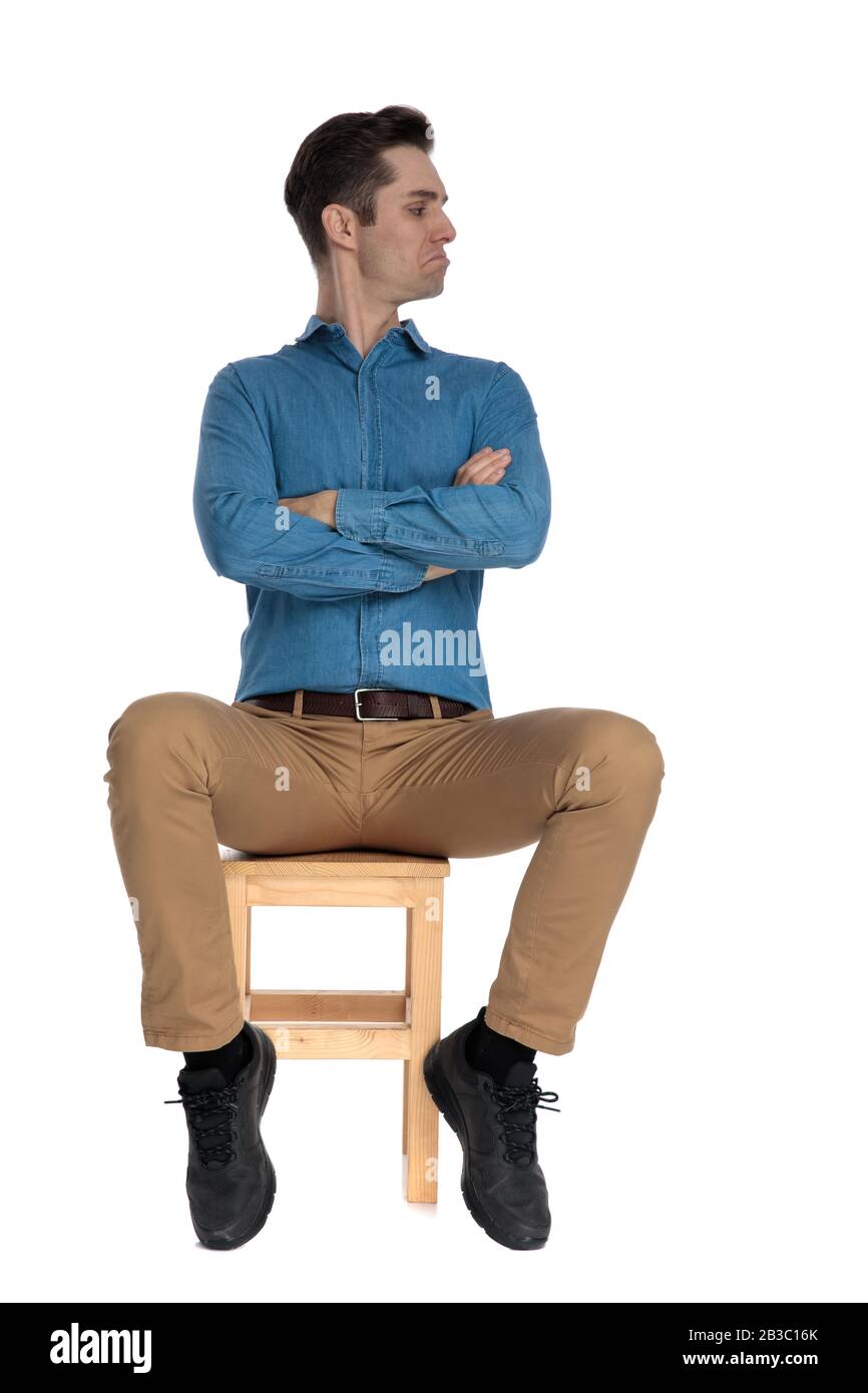 curious young man looking over shoulder to side, sitting isolated on ...