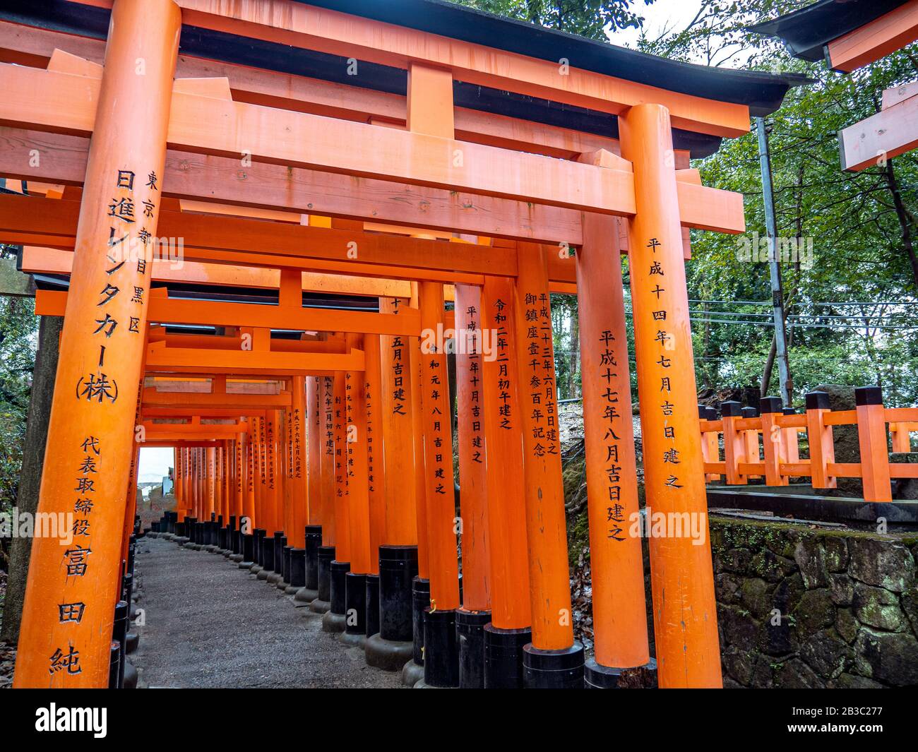 Beautiful orange tori gates line the path to the Fushimi Inari Taisha ...