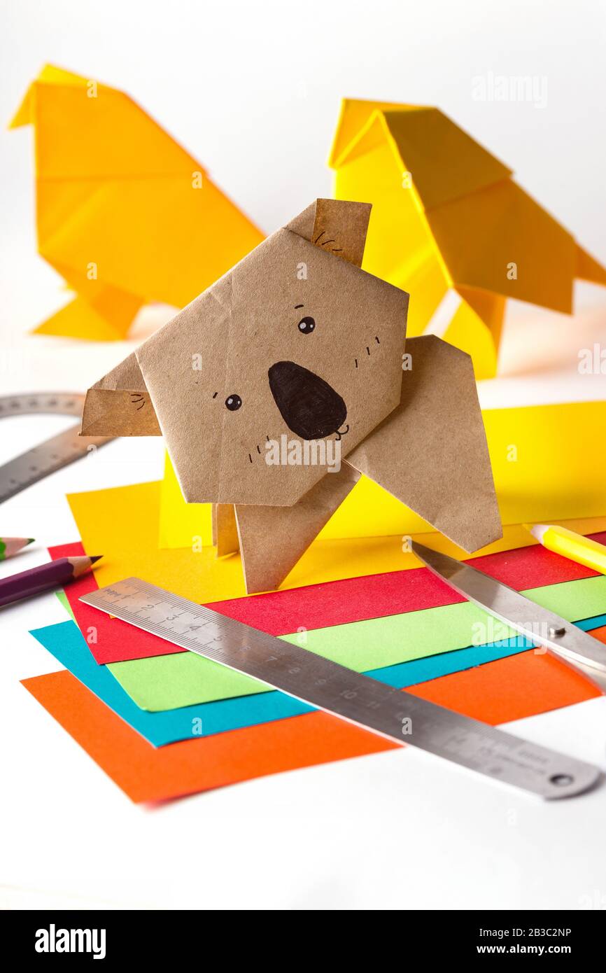 origami bird and koala made of colored paper. paper, ruler, pencils ...