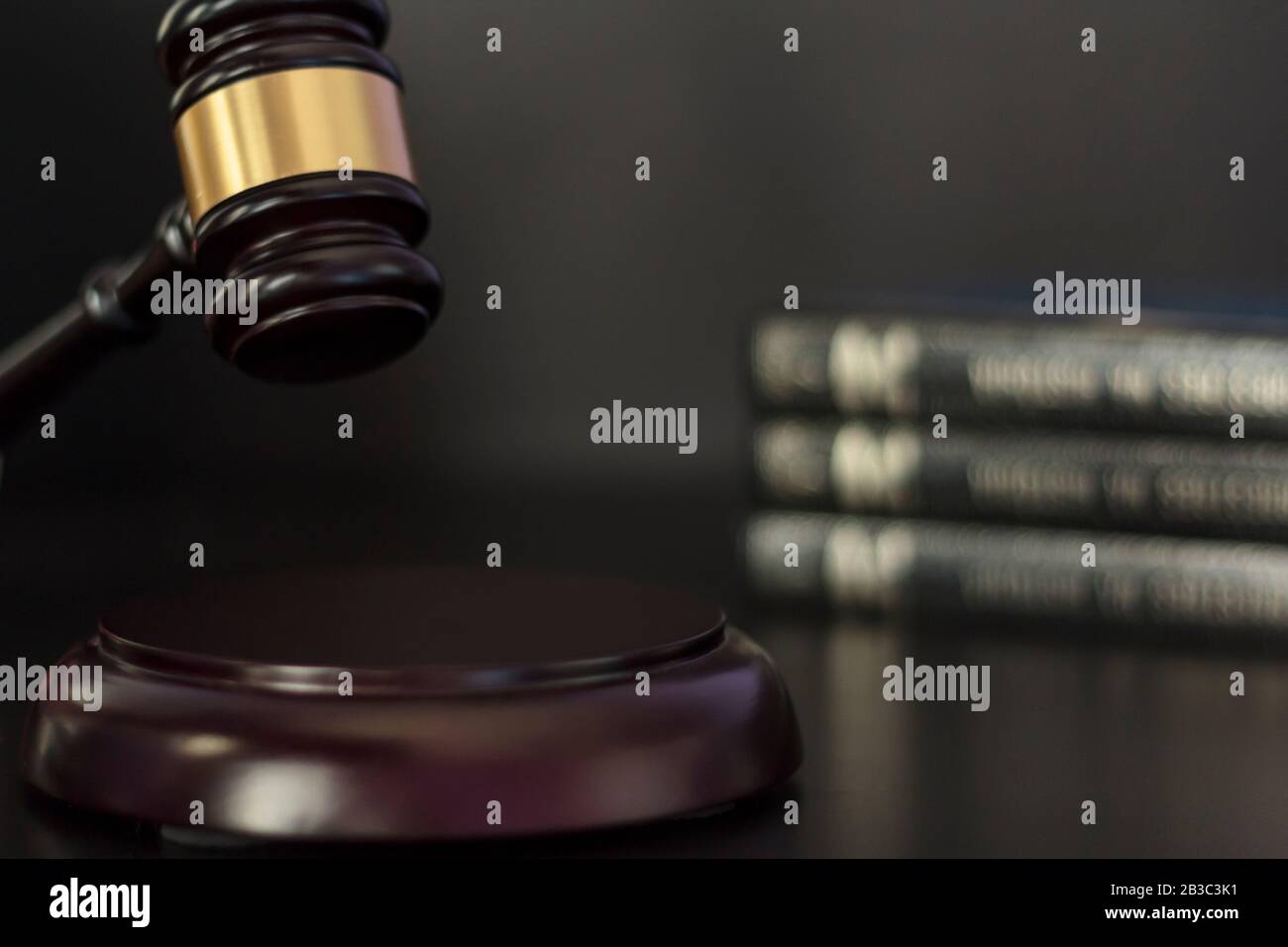 Judge's gavel hitting block with books on the background. Law and ...