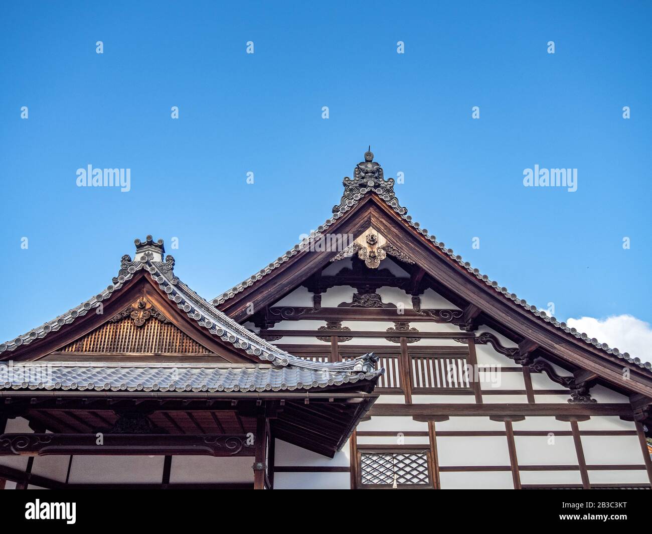 Traditional Japanese peaked roofs with Imperial Chrysanthemum symbols ...