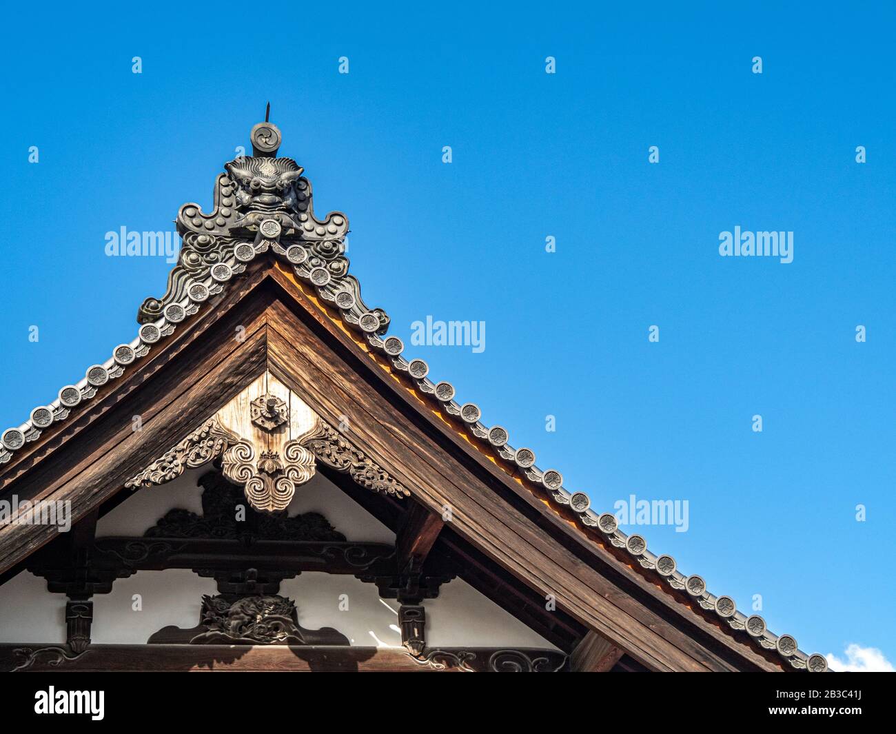 Traditional Japanese peaked roofs with Imperial Chrysanthemum symbols ...