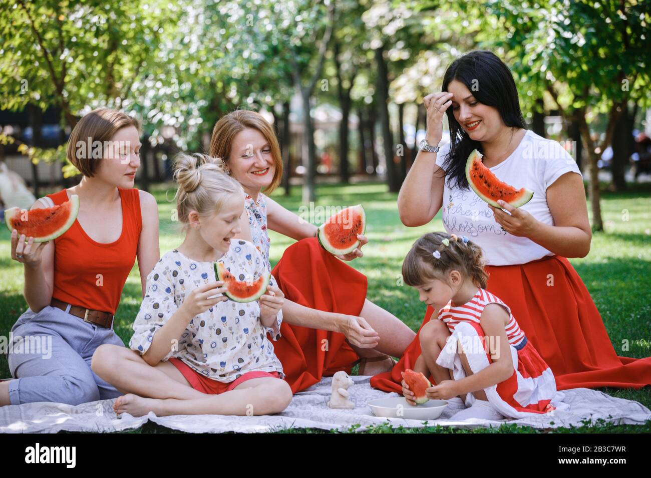 Summer - big happy family at a picnic with watermelon. Fun juicy summer ...