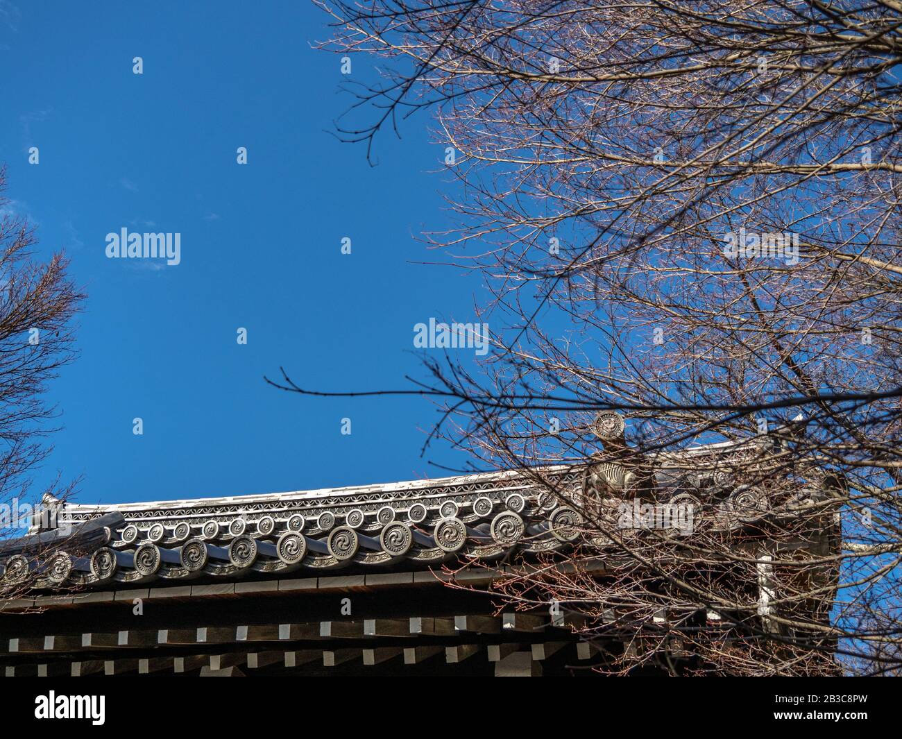 Traditional Japanese peaked roofs with Imperial Chrysanthemum symbols ...