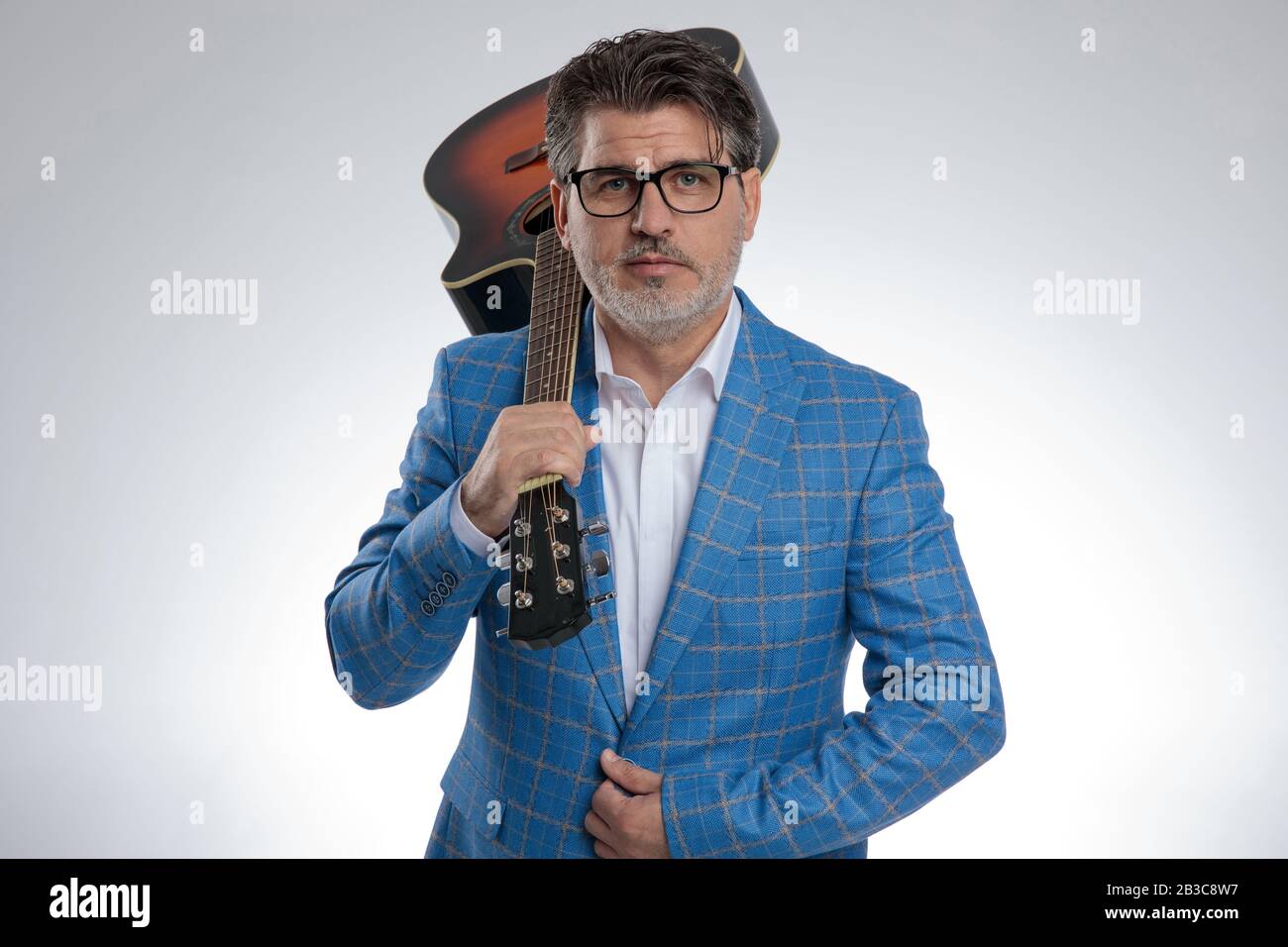 portrait of a good looking formal business man wearing a light blue ...