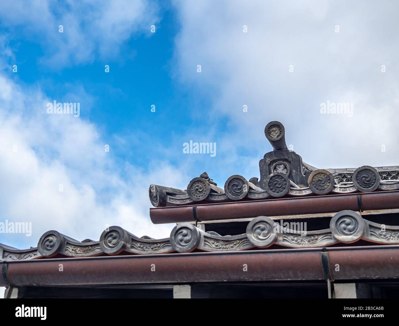 : Traditional Japanese peaked roofs with Imperial Chrysanthemum symbols ...