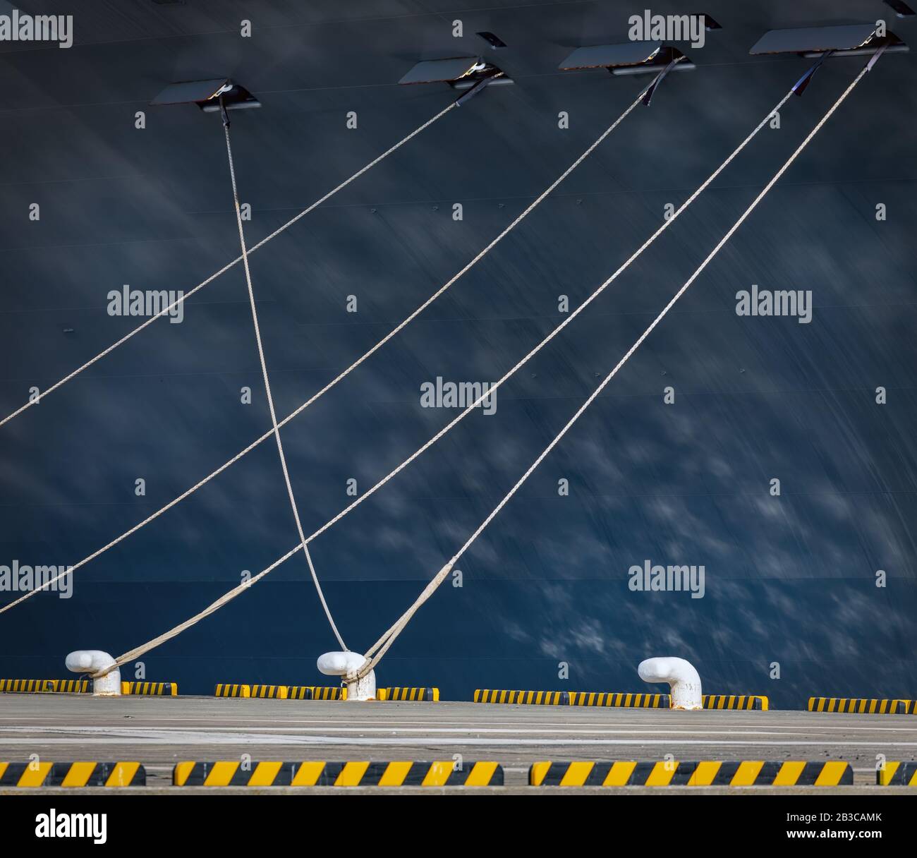 A Japan Maritime Self-Defense Force (JMSDF) ship is securely moored to ...