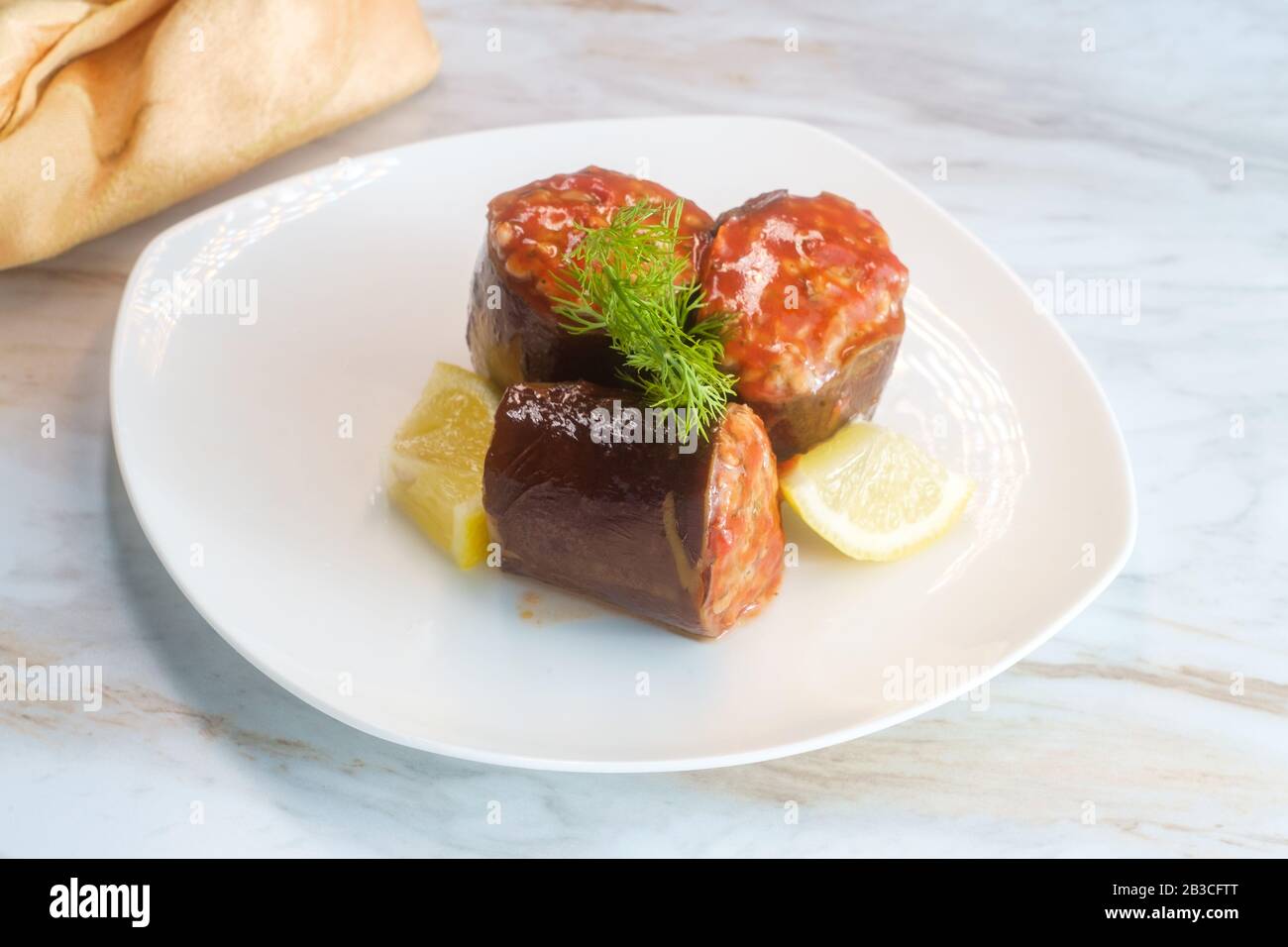 Rice and tomato sauce stuffed Israeli eggplant appetizer with lemon and ...