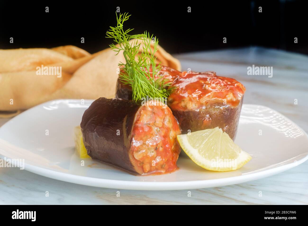 Rice and tomato sauce stuffed Israeli eggplant appetizer with lemon and ...