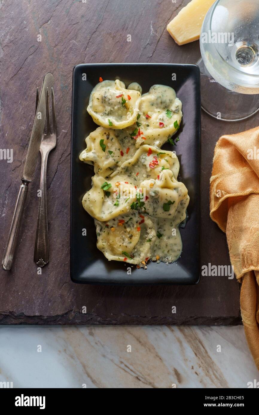 Herbed butter and parmesan cheese tortelloni in alfredo sauce Stock ...