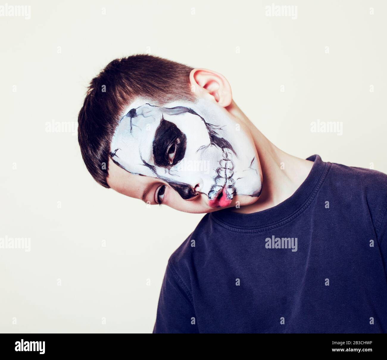 little cute boy with facepaint like skeleton to celebrate halloween ...