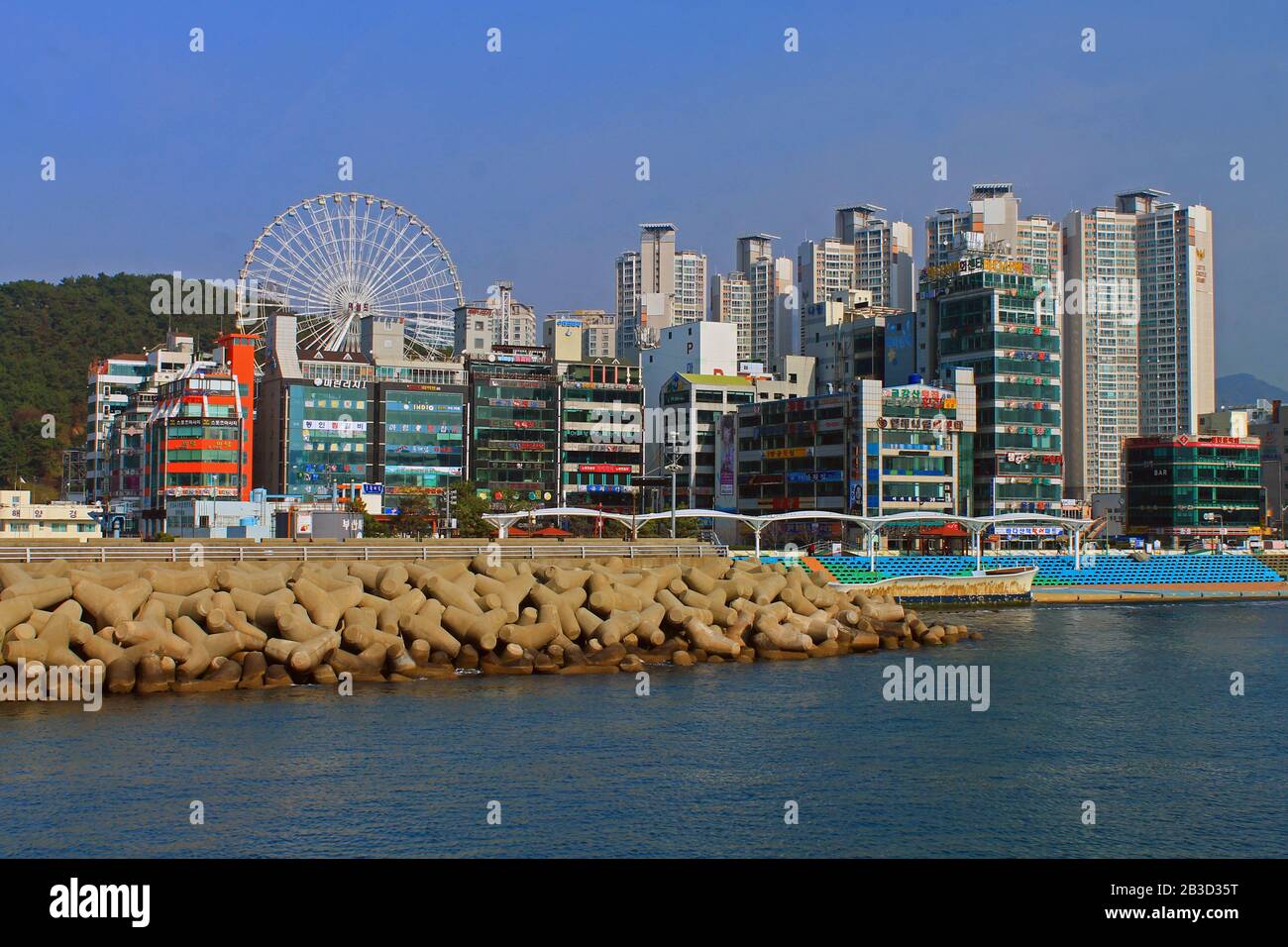 The buildings and the wheel of Busan Stock Photo - Alamy