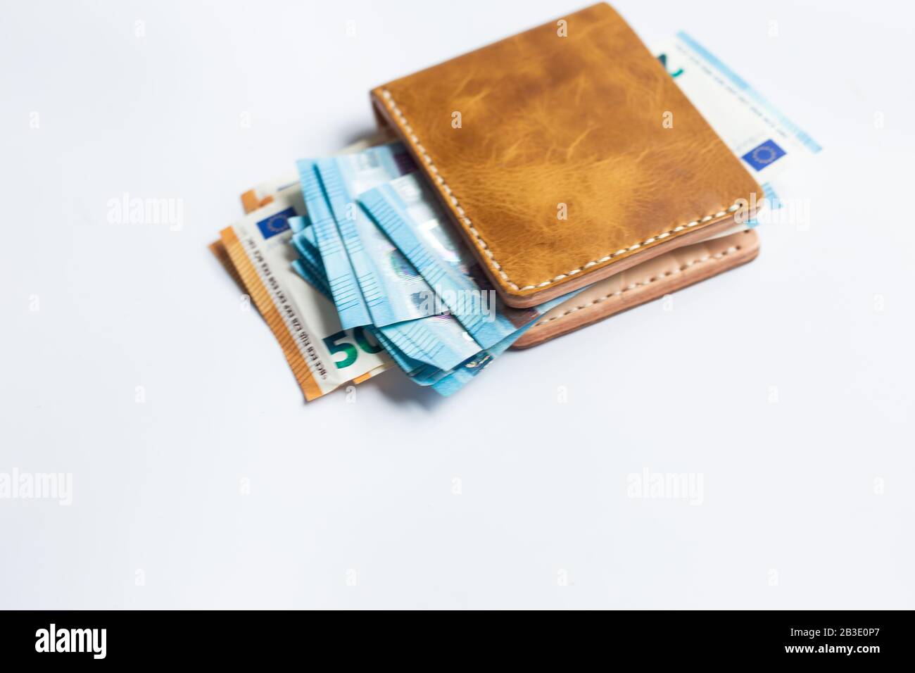 Leather bifold wallet with euro money bill on white background Stock ...