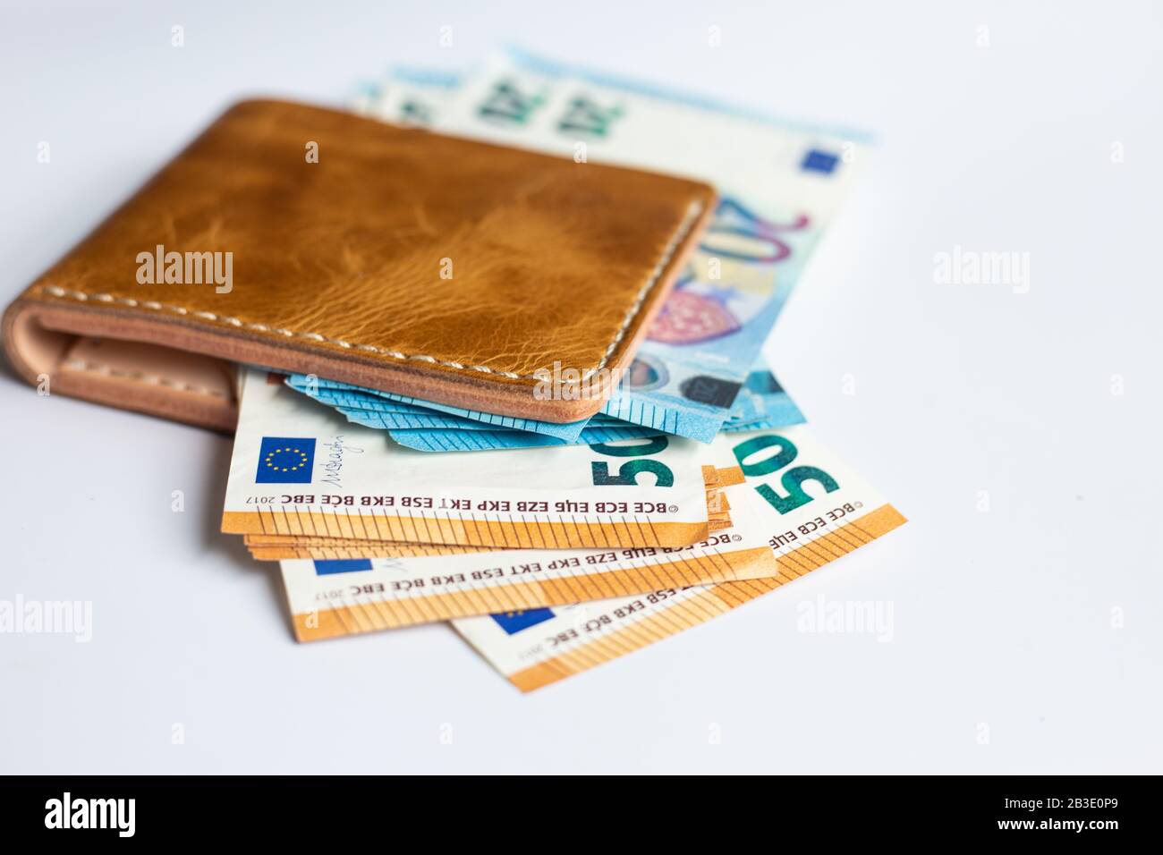 Leather bifold wallet with euro money bill on white background Stock ...