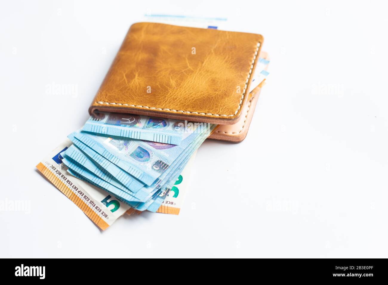 Leather bifold wallet with euro money bill on white background Stock ...