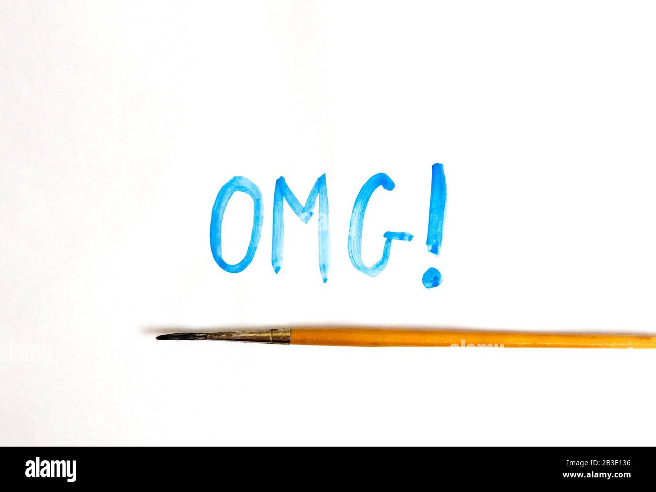 Handwritten OMG text with brush and watercolor paints on white ...