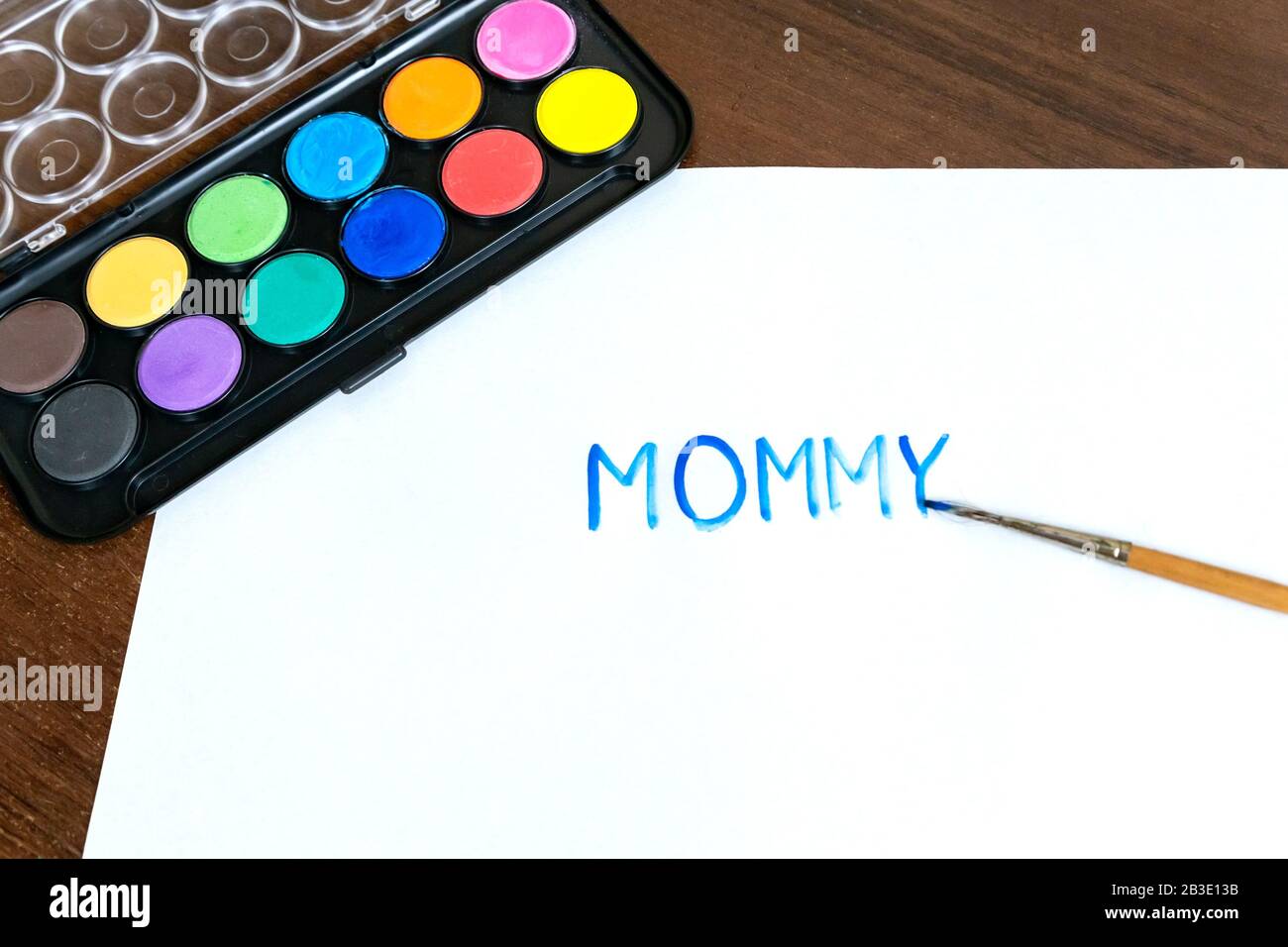 Handwritten MOMMY text with brush and watercolor paints on white ...