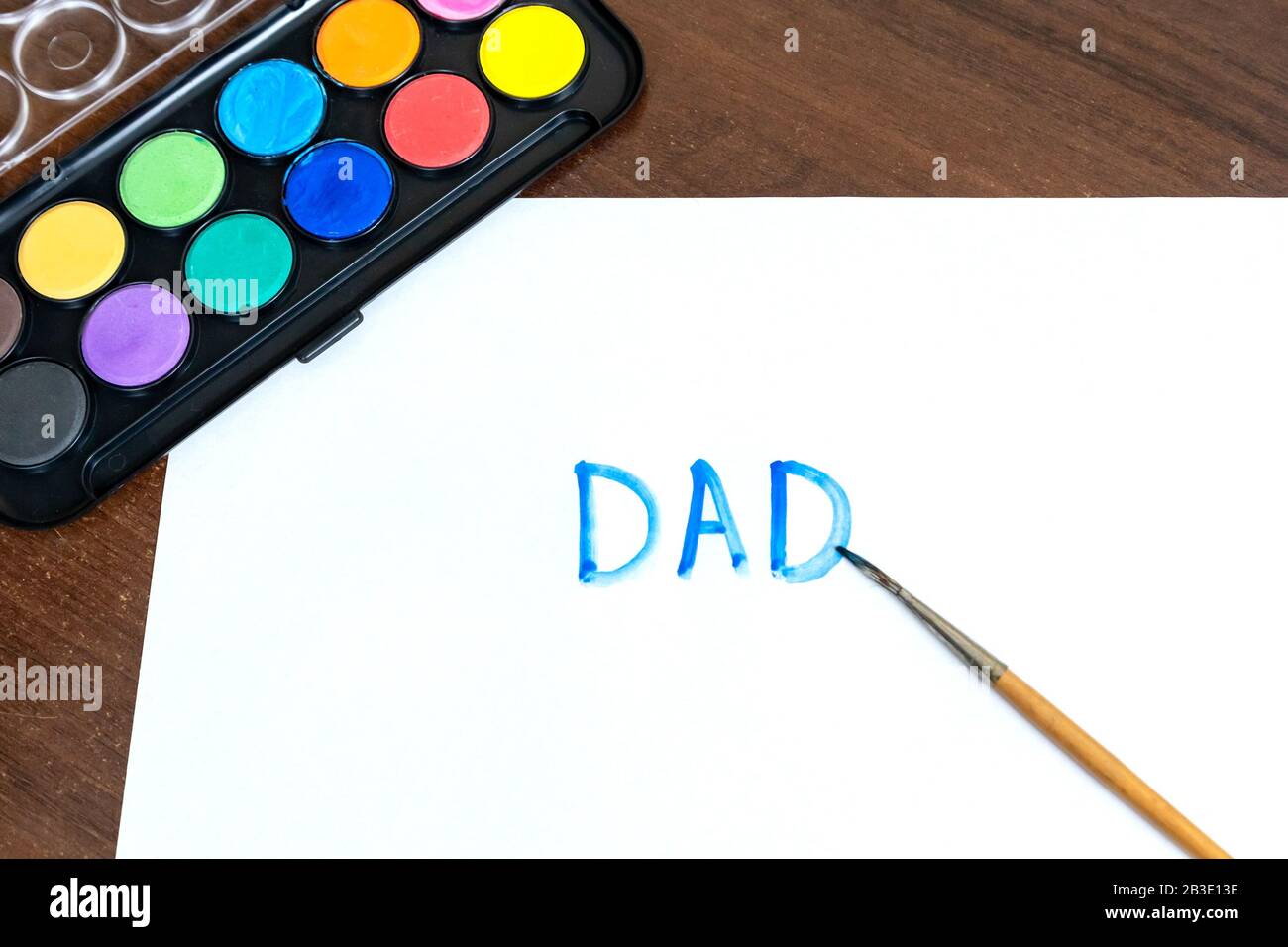 Handwritten DAD text with brush and watercolor paints on white ...