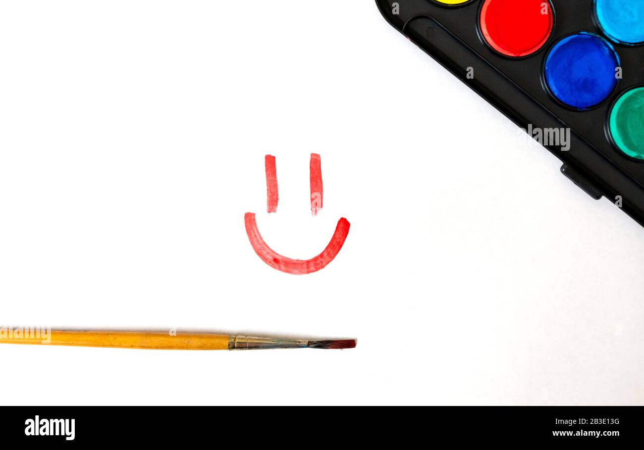 Smile face painted with brush and watercolor paints on white background ...