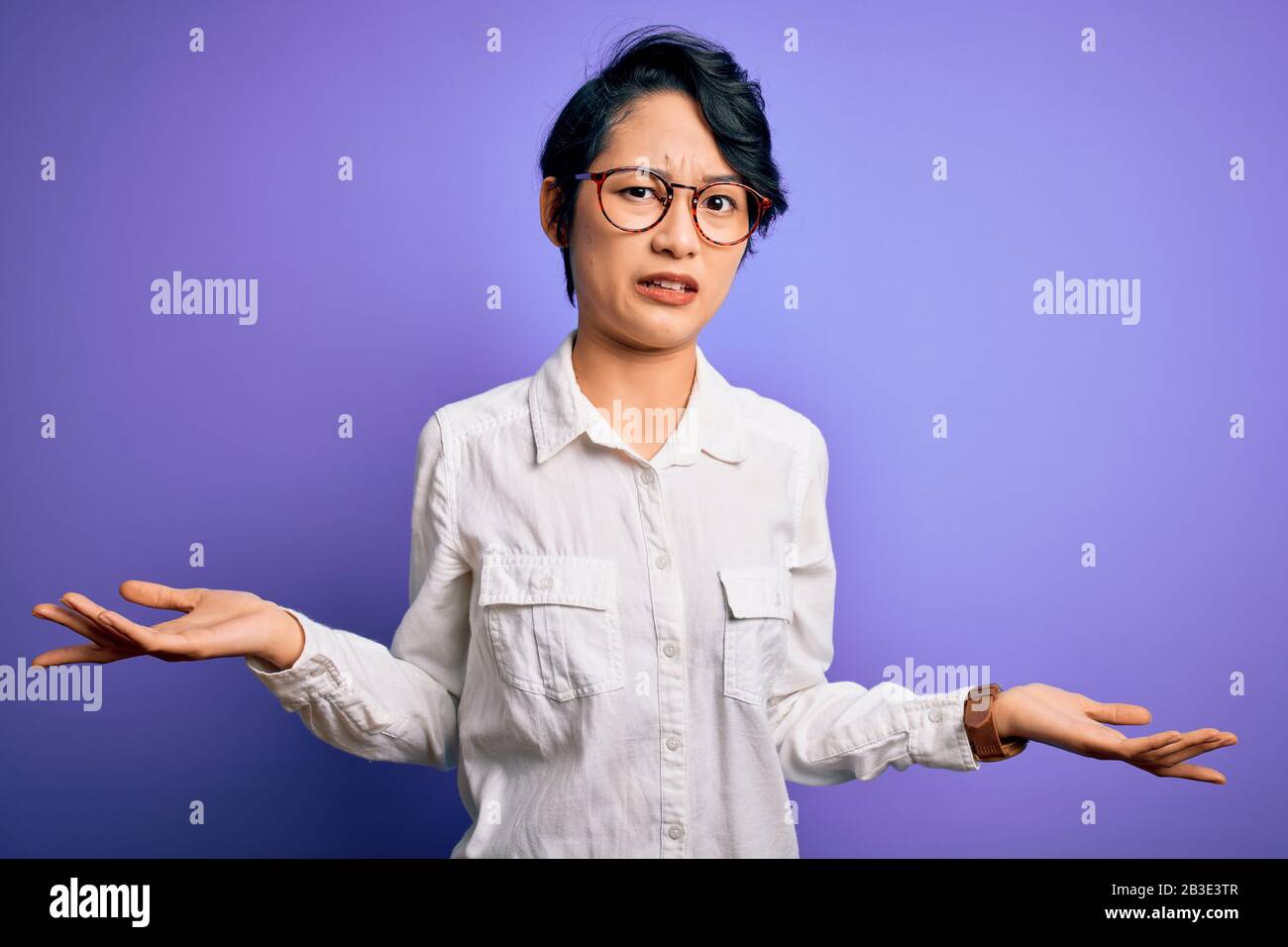 Young beautiful asian girl wearing casual shirt and glasses standing ...