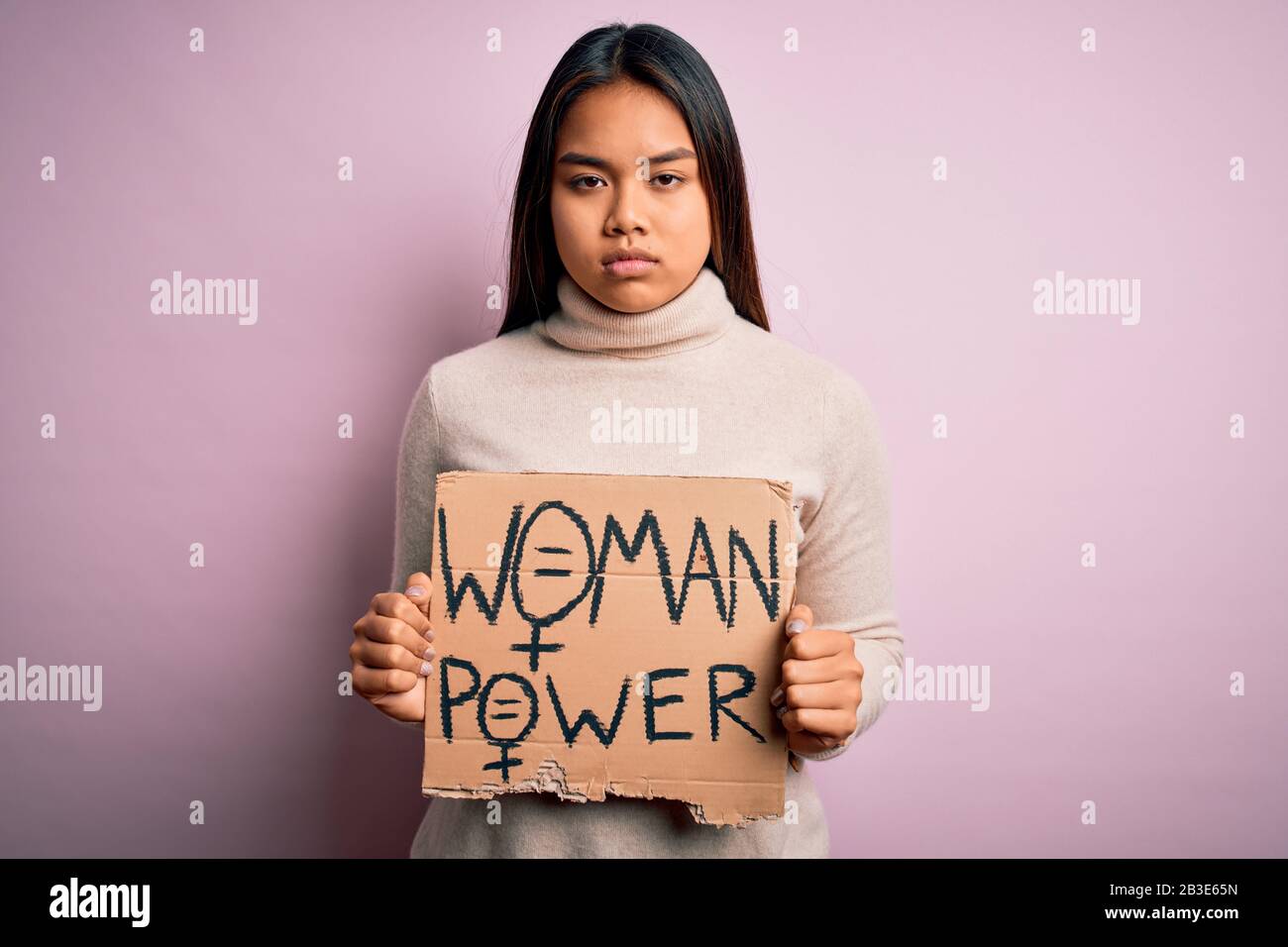 Young asian activist girl asking for women rights holding banner with ...