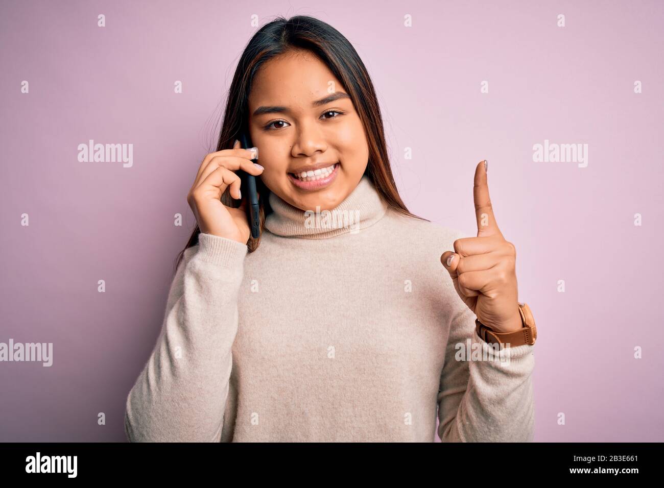 Young asian girl having conversation talking on the smartphone over ...
