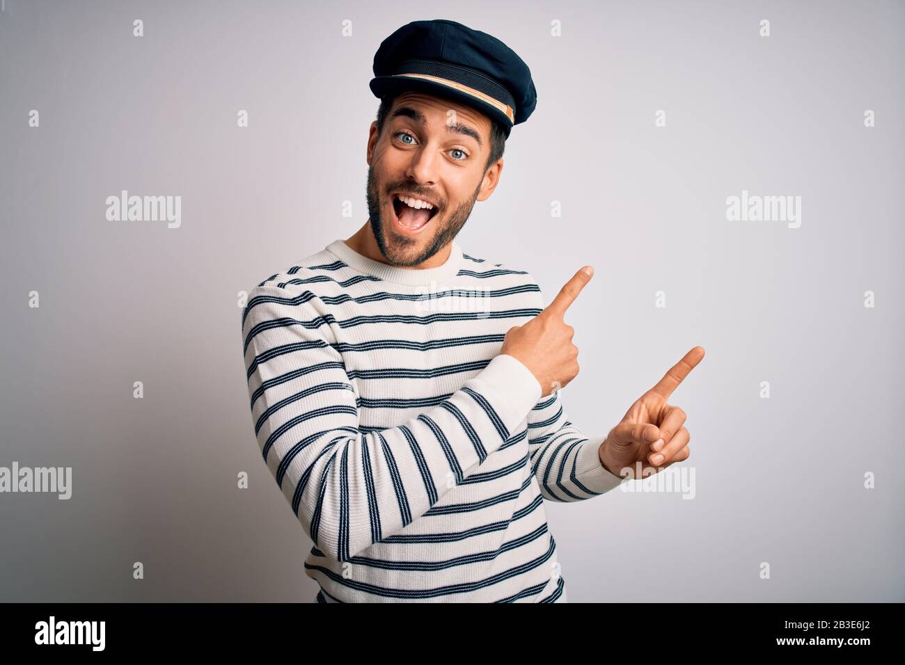 Young handsome sailor man with beard wearing navy striped uniform and ...
