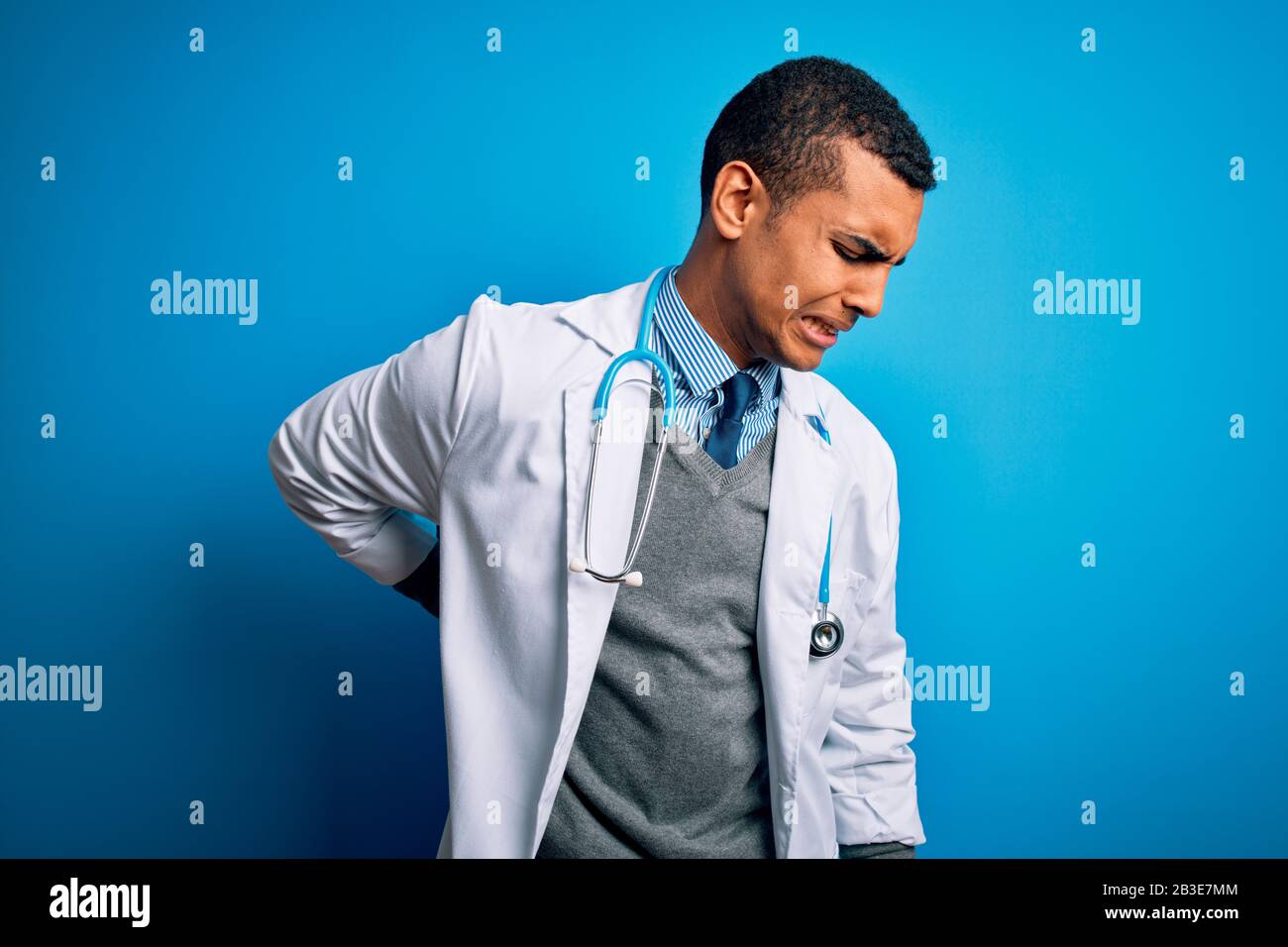 Handsome african american doctor man wearing coat and stethoscope over ...
